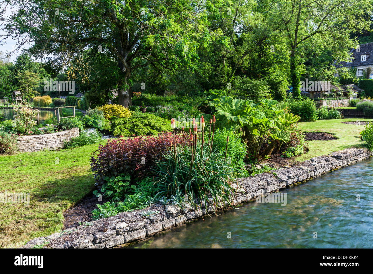 The pretty landscaped garden of the Trout Farm in the Cotswold village ...