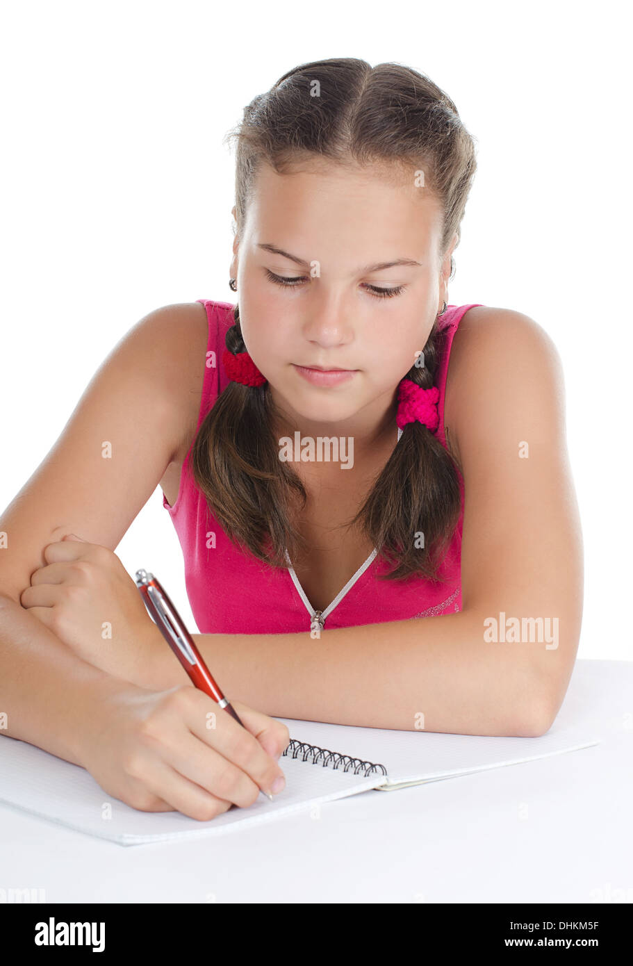 The young girl writes to writing-books Stock Photo - Alamy