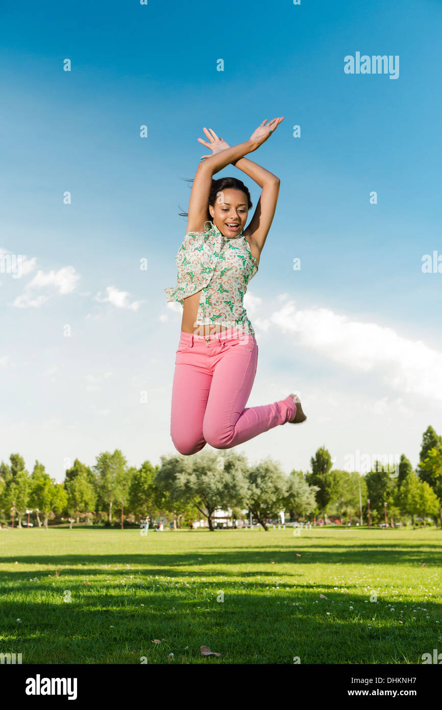 Outdoor portrait of a beautiful African American woman jumping Stock ...