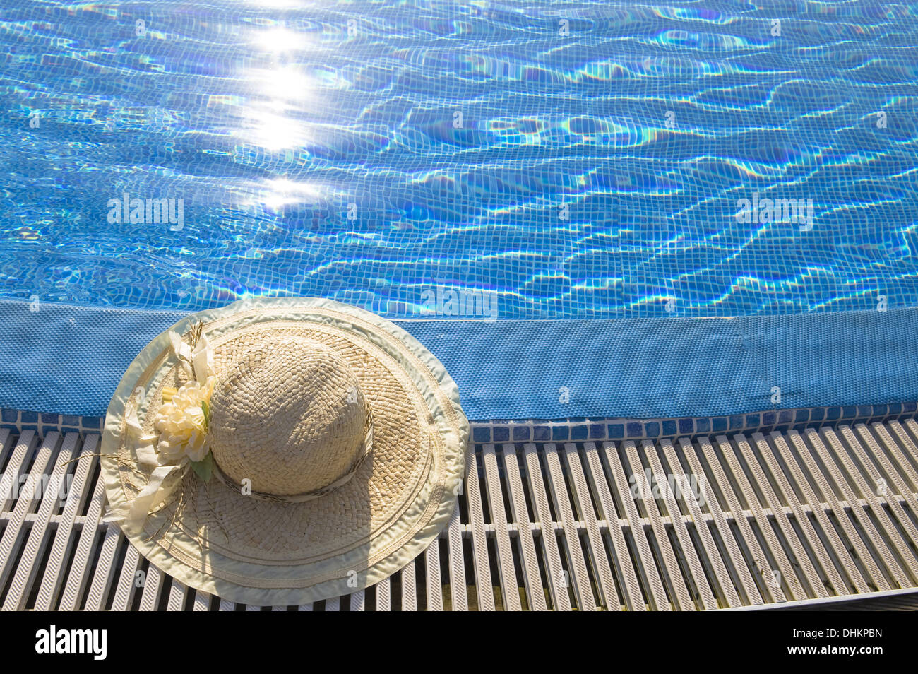 straw hat lies on the brink of pool Stock Photo - Alamy