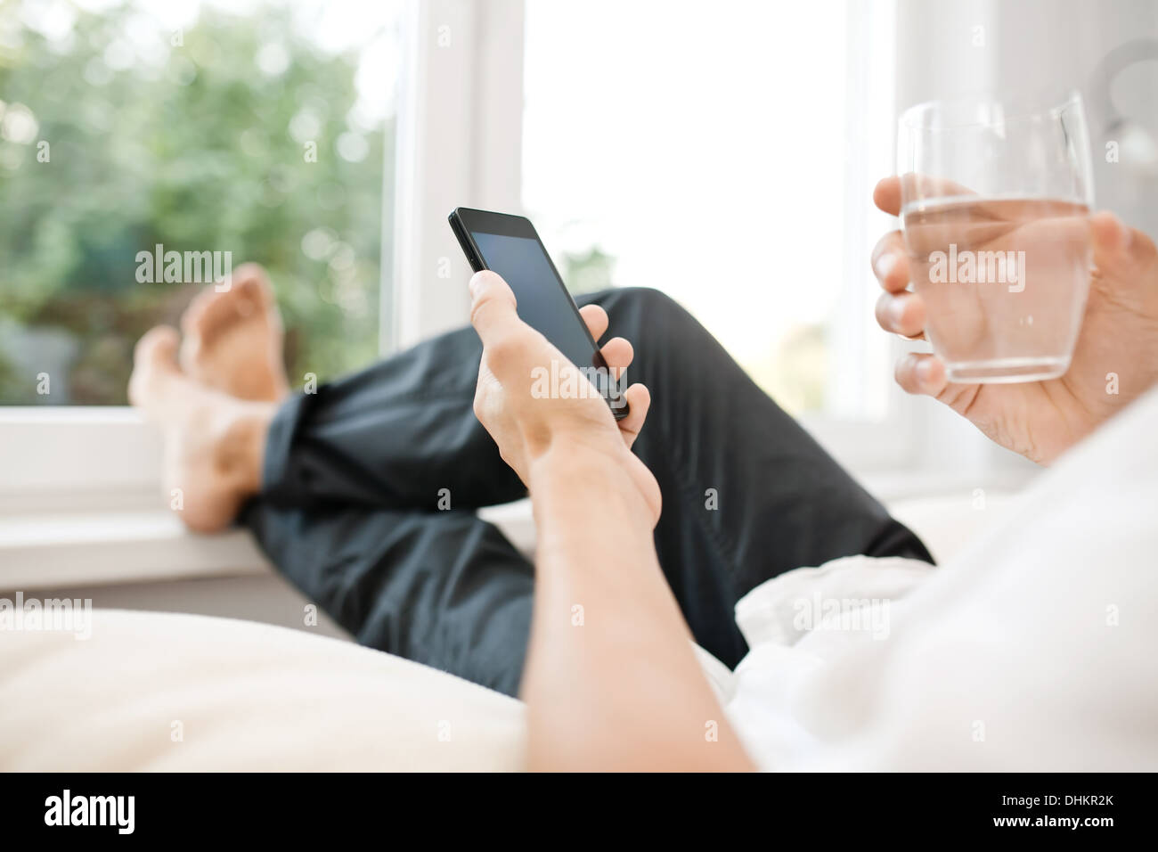 Relaxing using mobile phone close hi-res stock photography and images ...