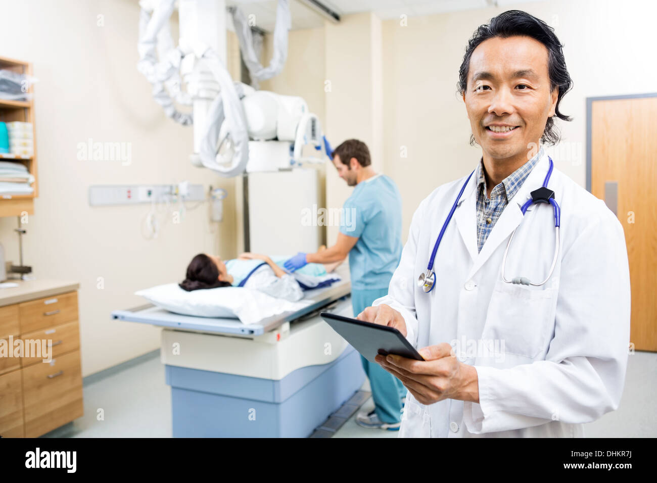 Doctor Using Digital Tablet In Hospital Room Stock Photo - Alamy