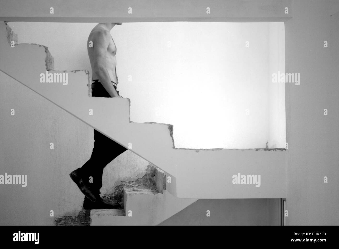 Man ascending a staircase Stock Photo - Alamy