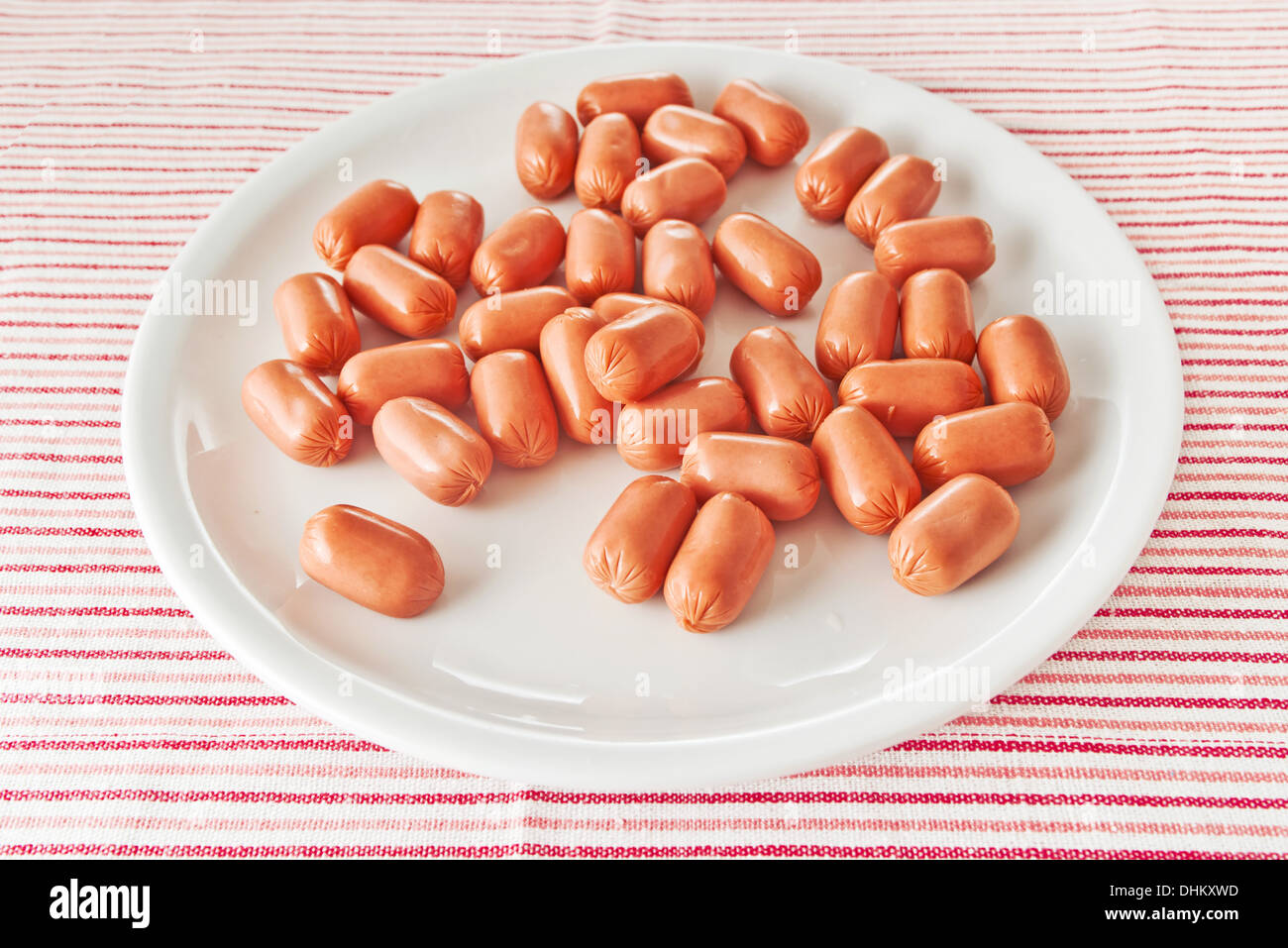 Small frankfurt sausages on white plate on table Stock Photo - Alamy