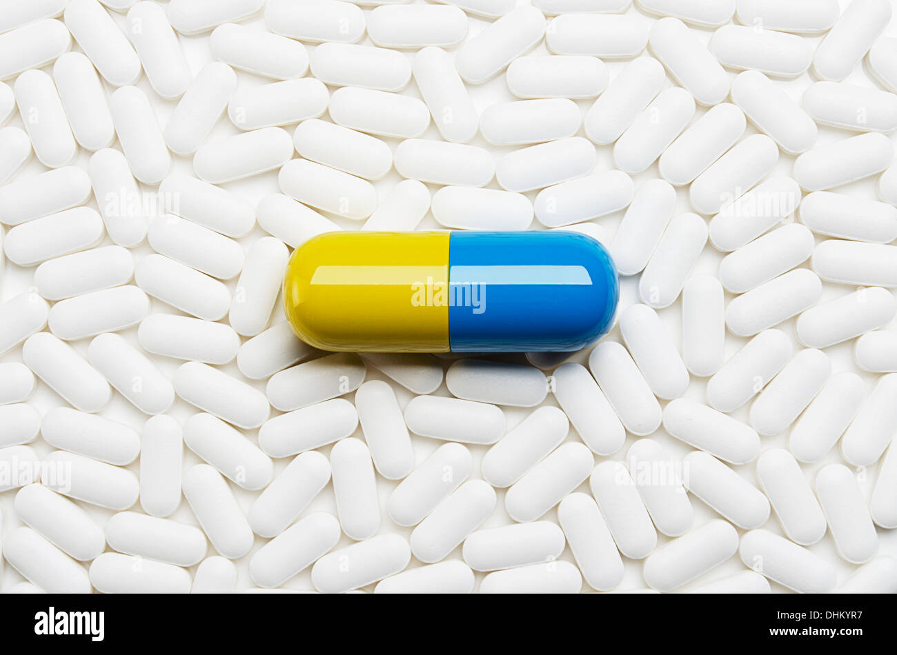 Large pill with small pills Stock Photo - Alamy