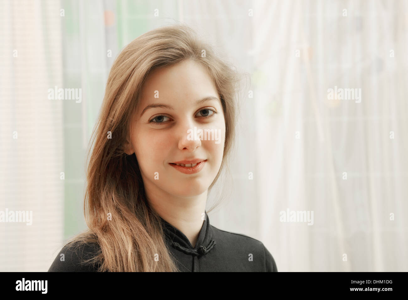Portrait of positive woman in black Stock Photo - Alamy