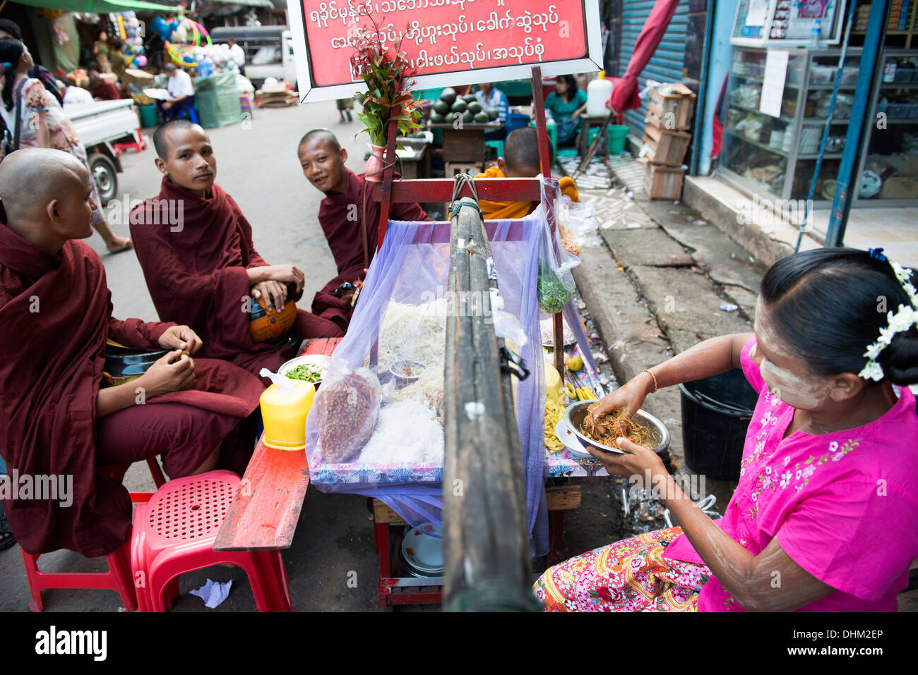 Burmese Buddhist monks enjoy lunch at a noodle street stall in Yangon ...