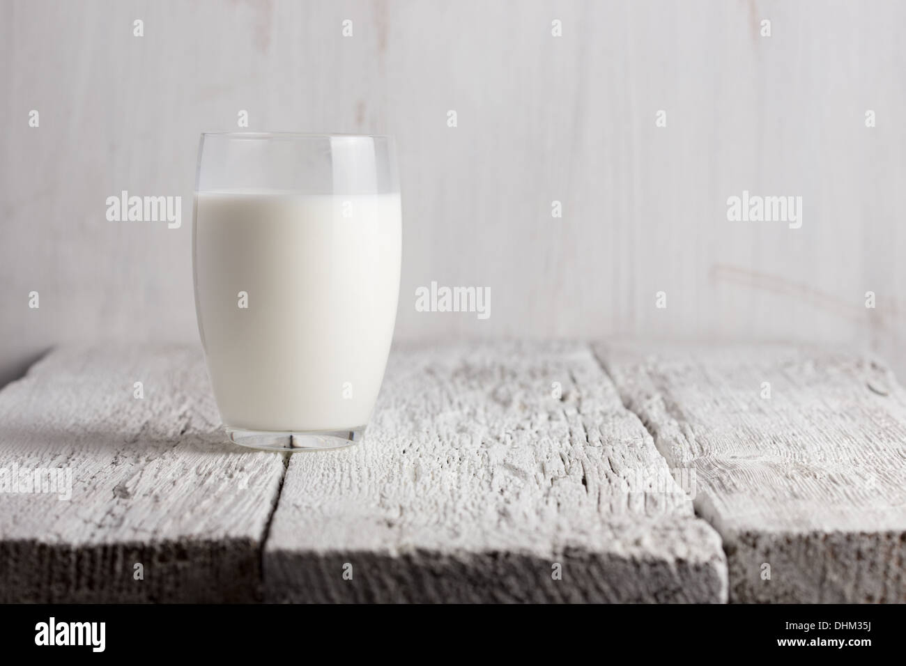 Glass of milk standing on table Stock Photo - Alamy