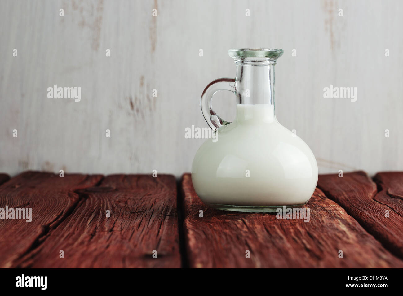 Glass of milk standing on table Stock Photo - Alamy
