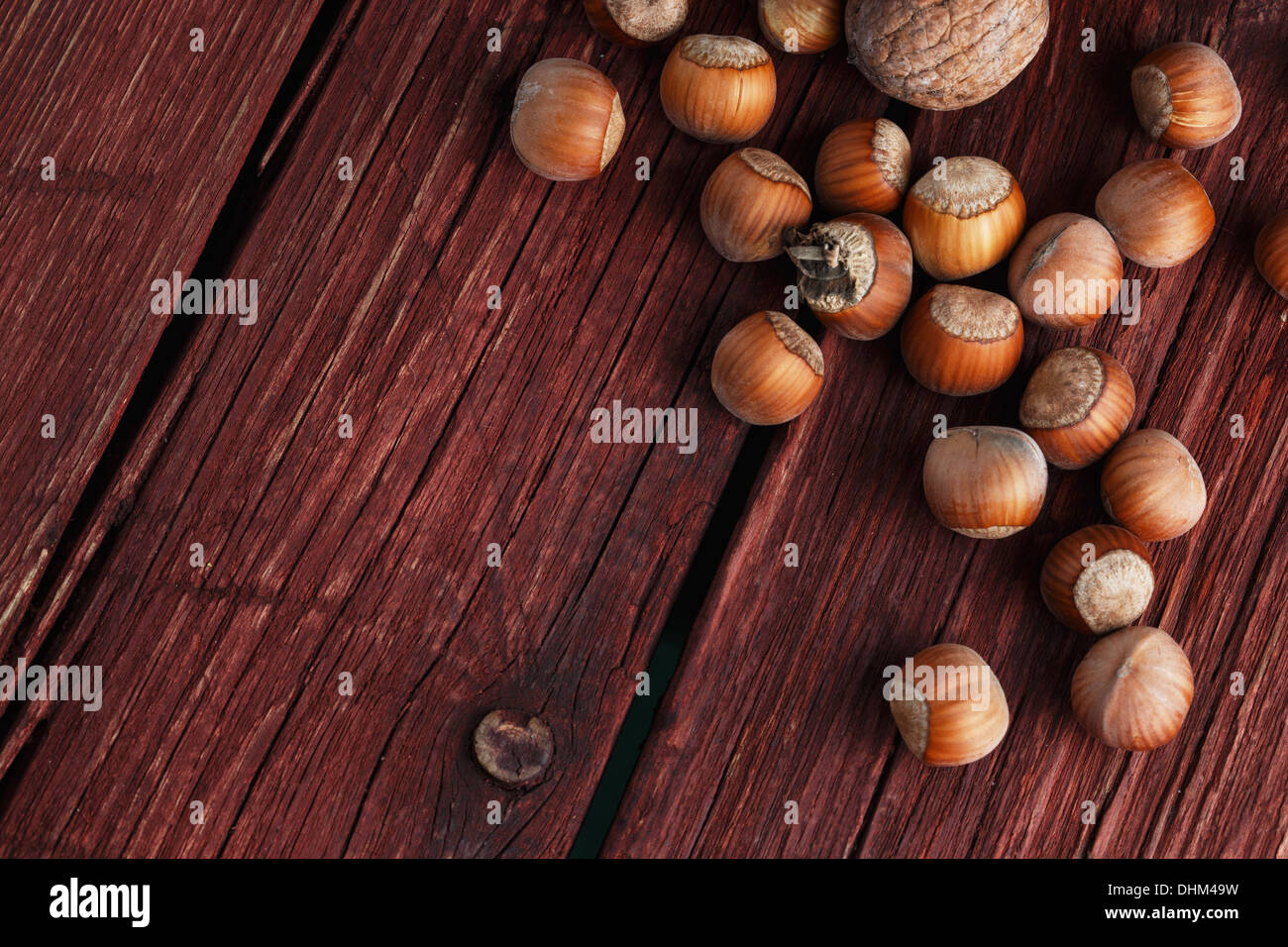 Walnuts and hazelnuts on rustic dark wood background Stock Photo - Alamy