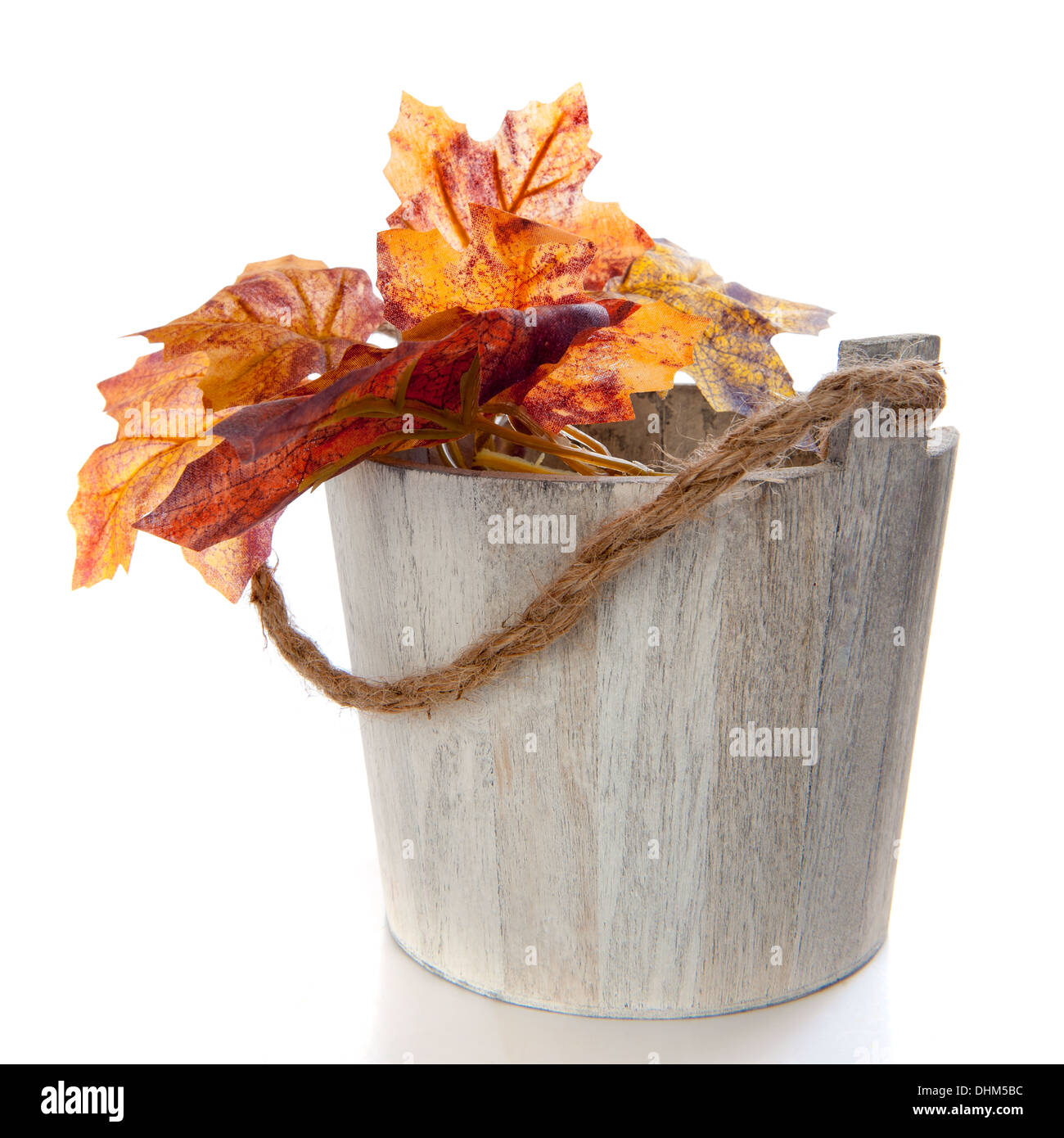a wooden bucket full of autumn leaves on a white background Stock Photo ...