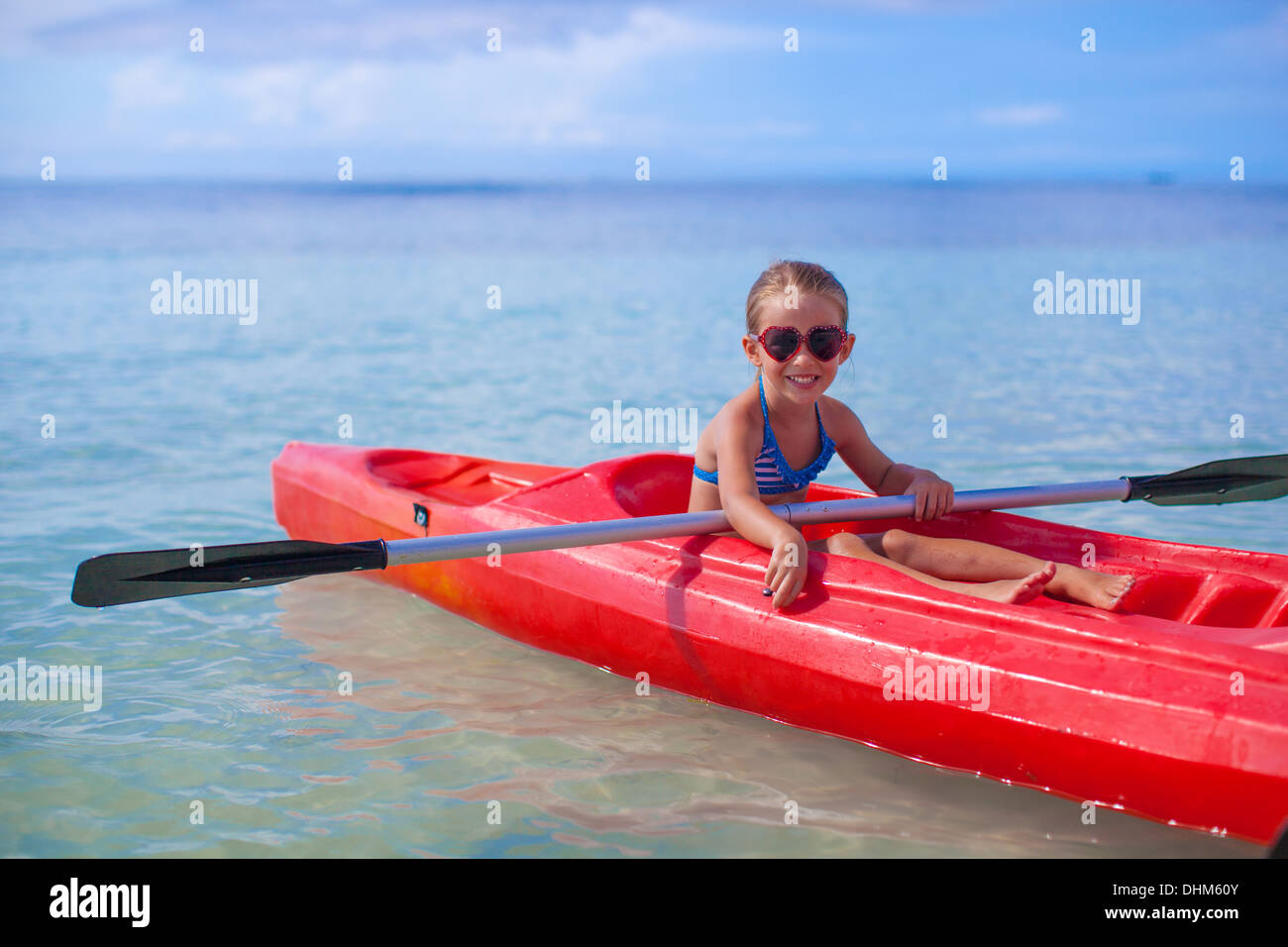 Little brave cute girl floating in a kayak on the high blue sea Stock ...