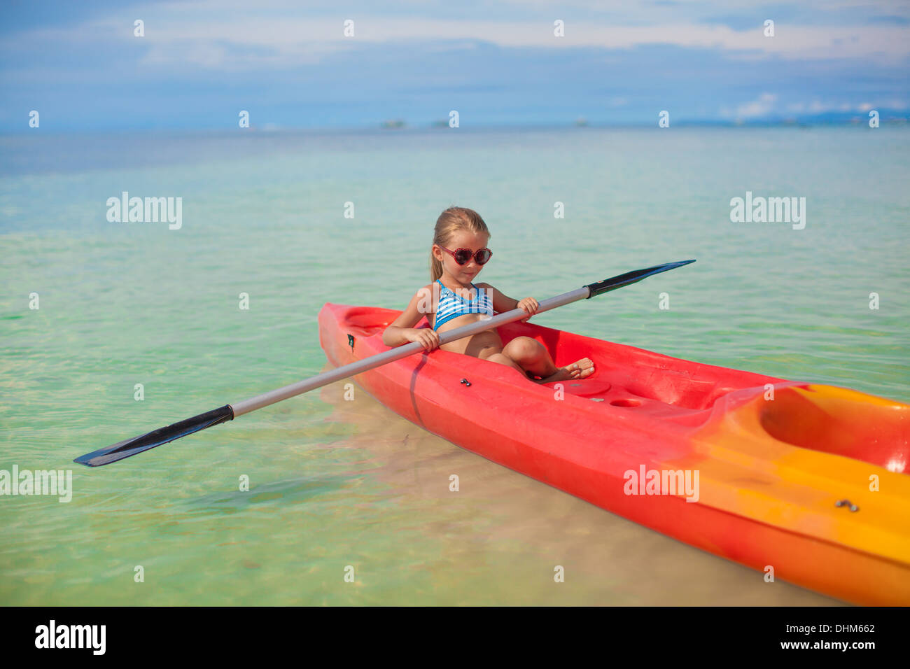 Little adorable girl rowing a boat in blue clear sea Stock Photo - Alamy