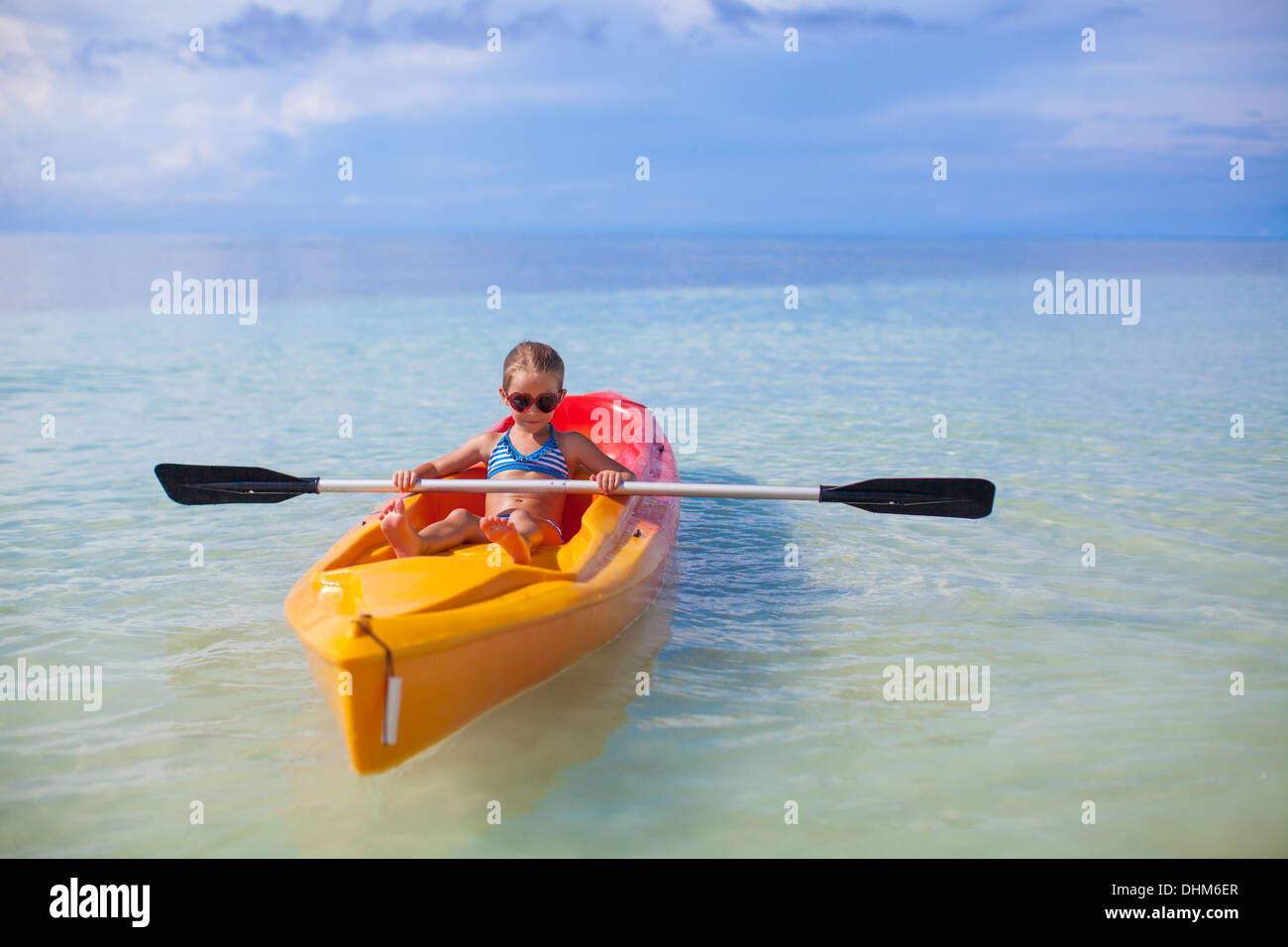 Little cute girl rowing a boat in blue clear sea Stock Photo - Alamy