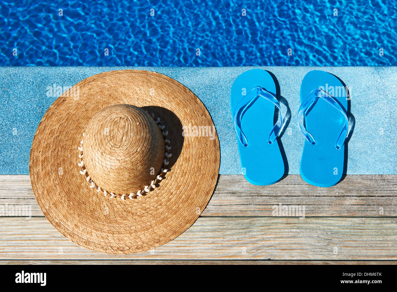 Blue slippers and hat by a swimming pool Stock Photo - Alamy
