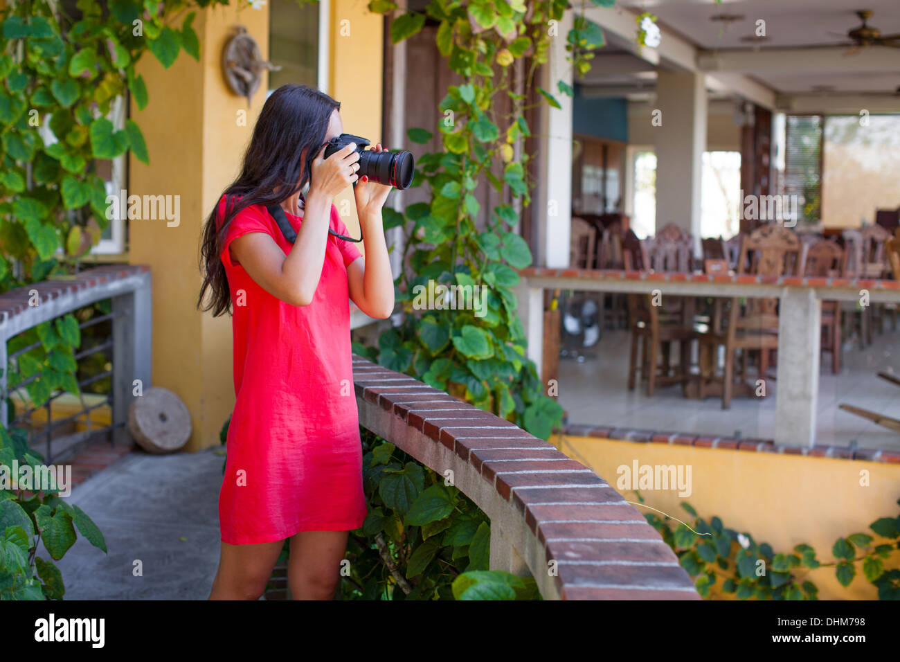 Young woman photographs the stunning view from cozy balcony Stock Photo ...