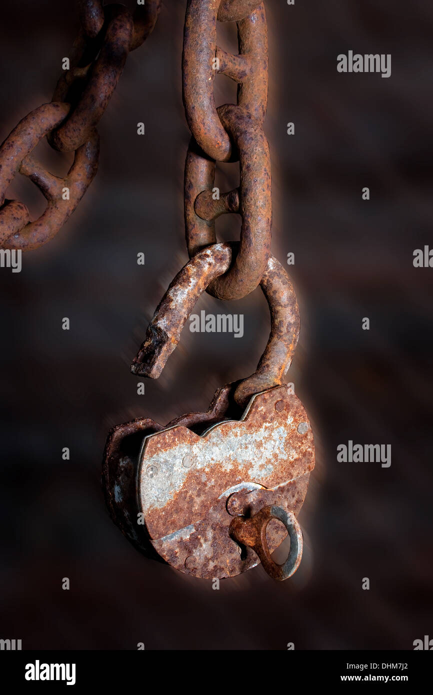Big old rusty metal open padlock with a key hanging on a bold chain ...