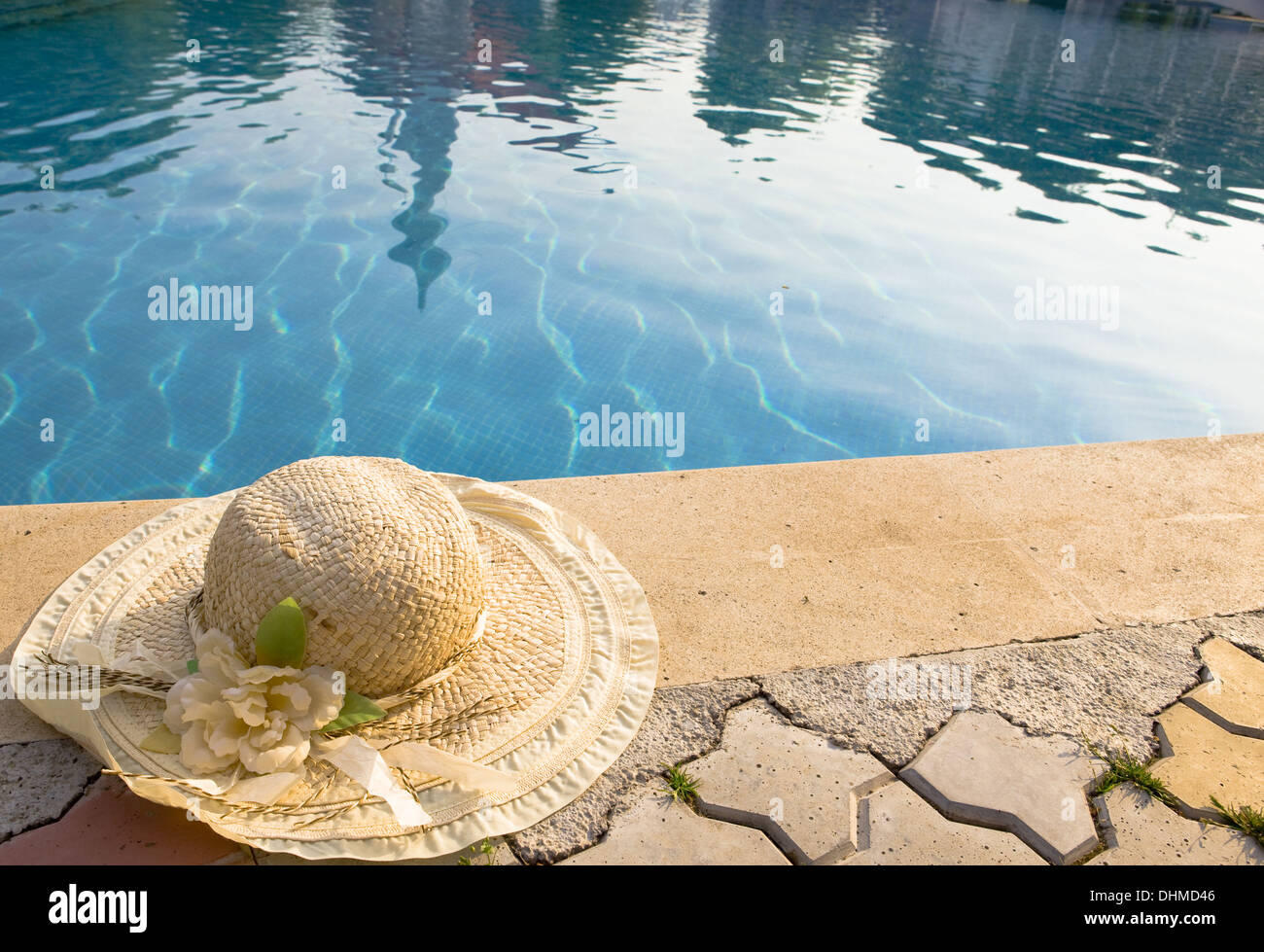 straw hat lies on the brink of pool Stock Photo - Alamy