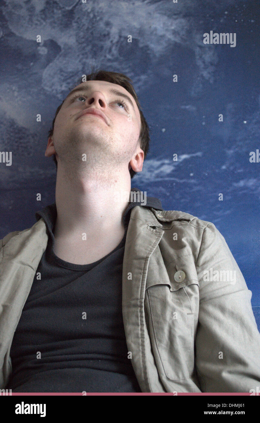 A male model in repose highlighting Adam's Apple Portrait with earth ...