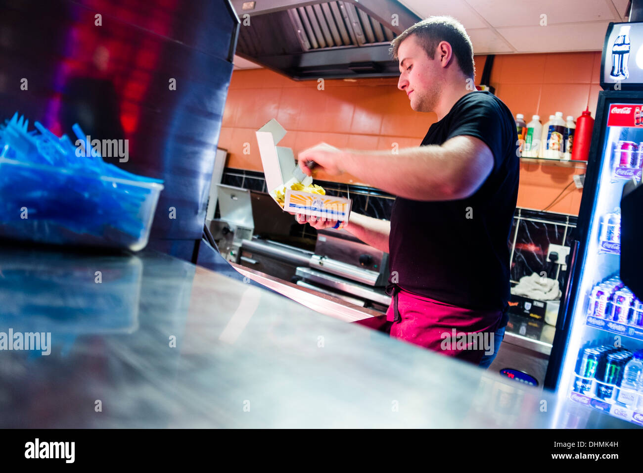 A man working in a fish and chip shop, UK Stock Photo - Alamy