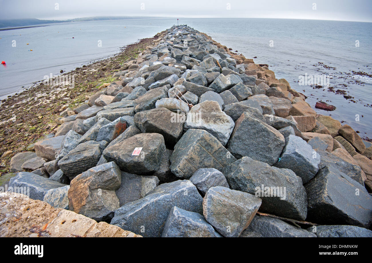 Rocks piled up on the beach at Lyme Regis to form a breakwater Stock ...