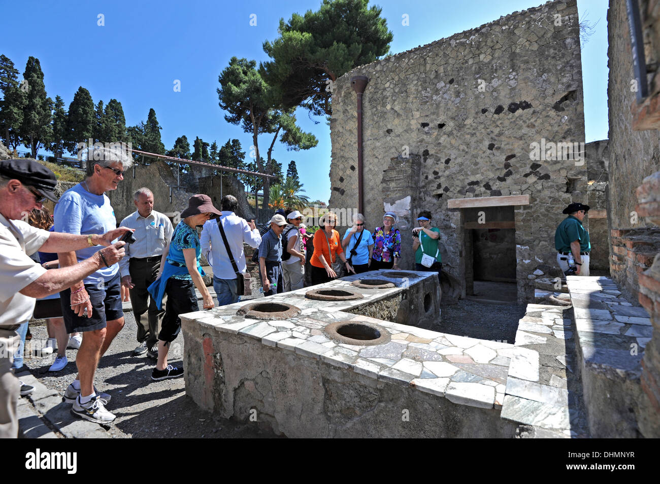 Tourists looking round The Grande Taberna, an Roman ancient pub with ...