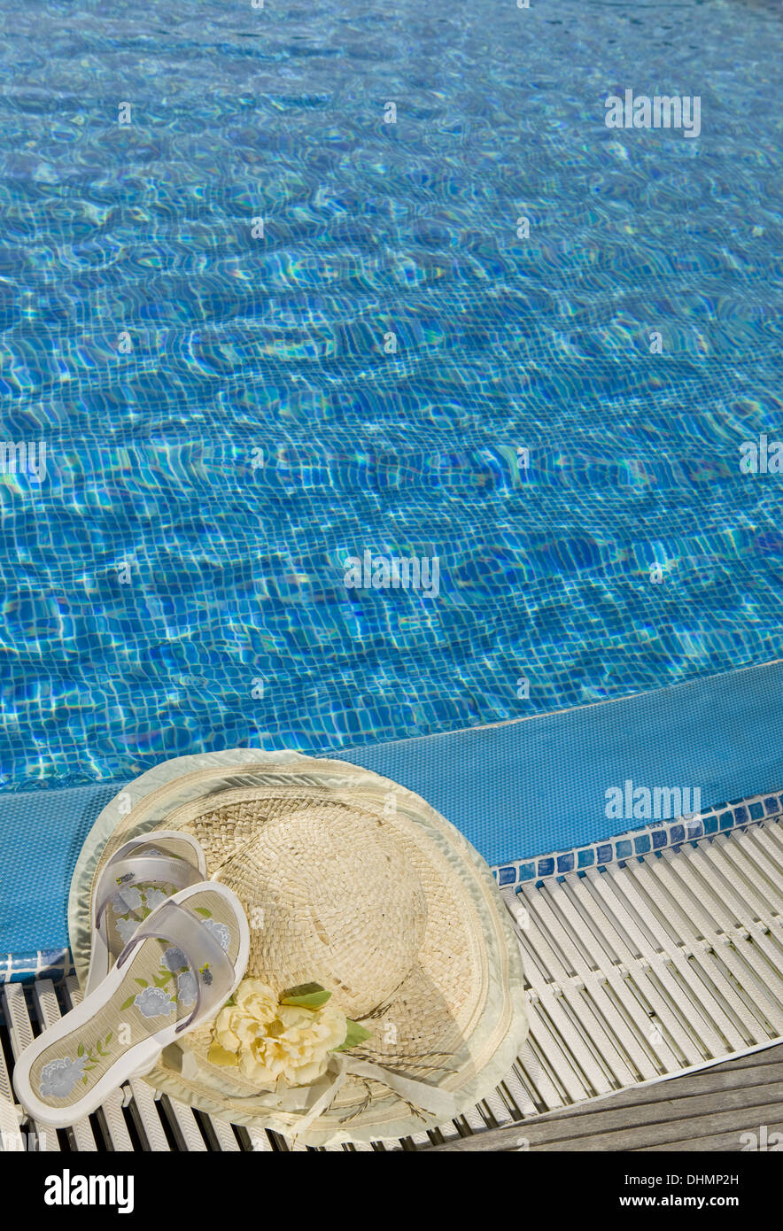 The straw hat lies on the brink of pool Stock Photo - Alamy
