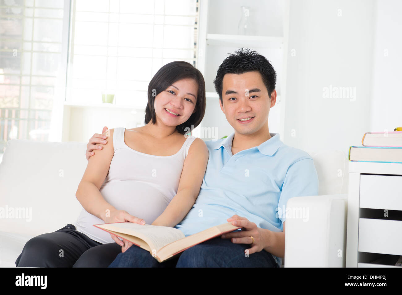 chinese pregnant father and mother reading Stock Photo - Alamy