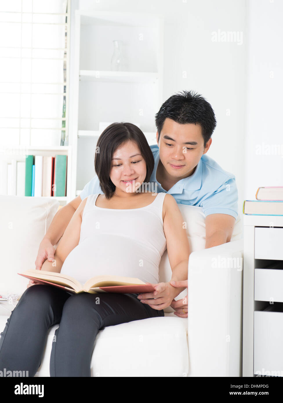 chinese pregnant father and mother reading Stock Photo - Alamy