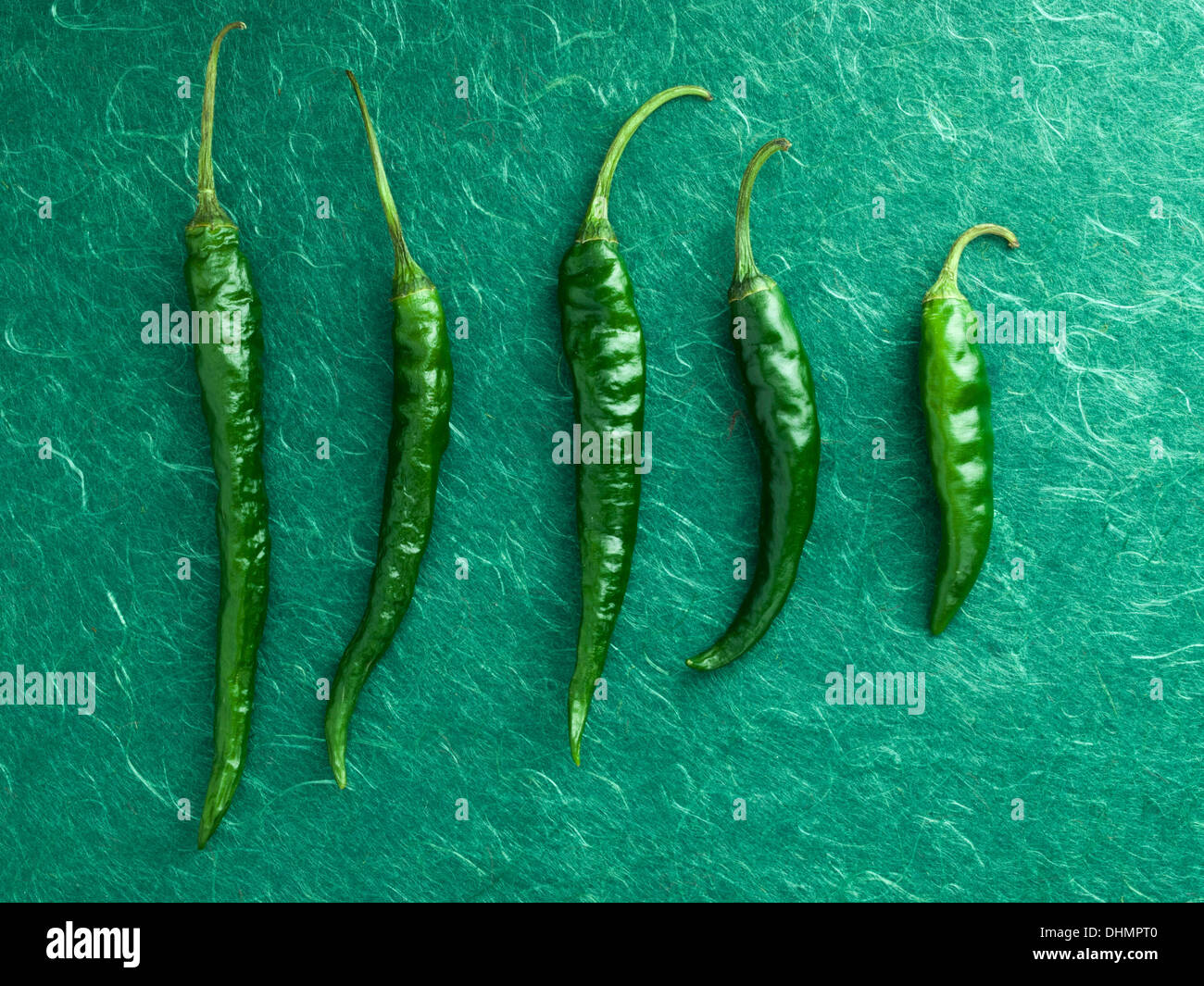 Chilli Peppers on coloured paper backgrounds Stock Photo - Alamy
