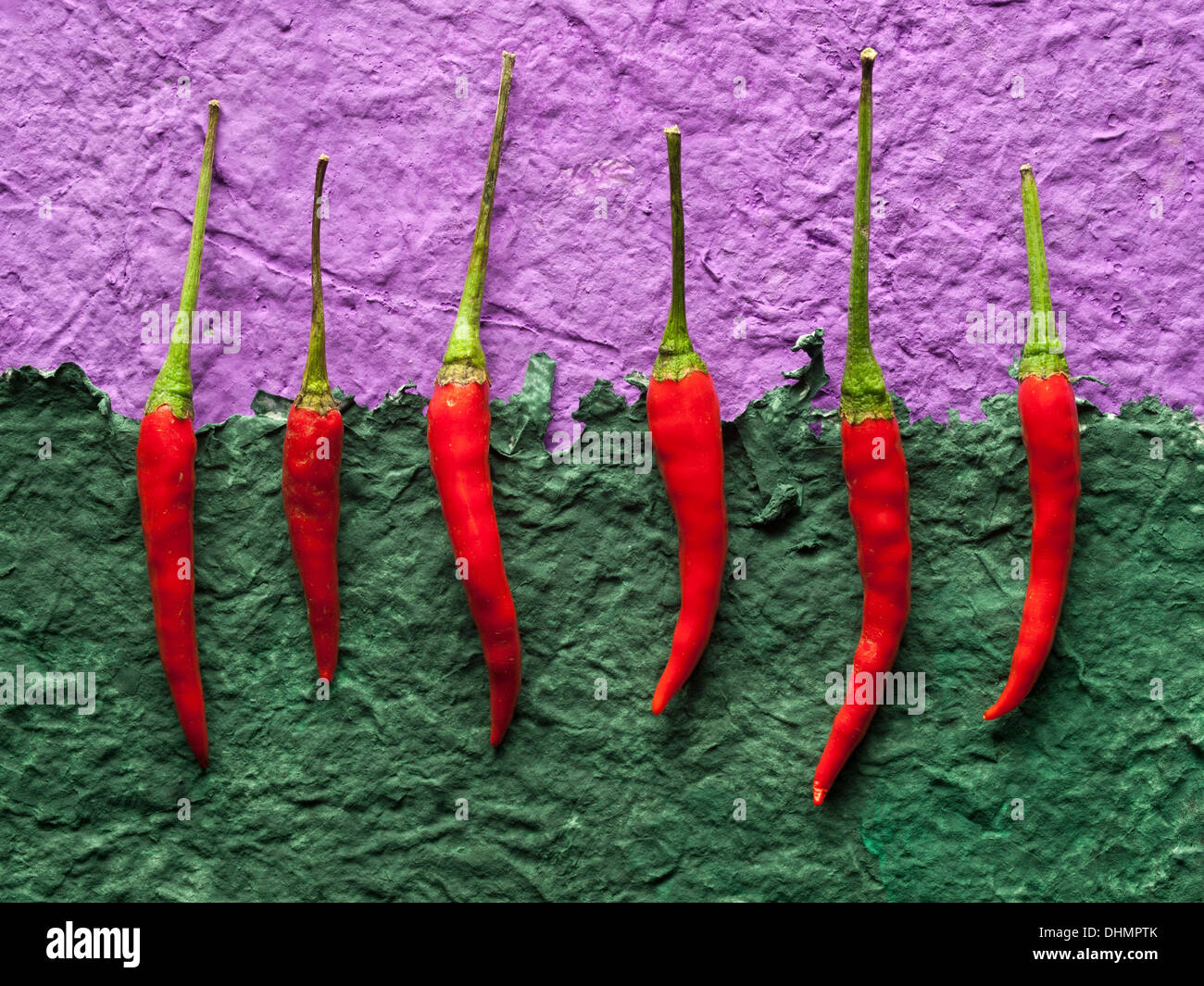 Chilli Peppers on coloured paper backgrounds Stock Photo - Alamy