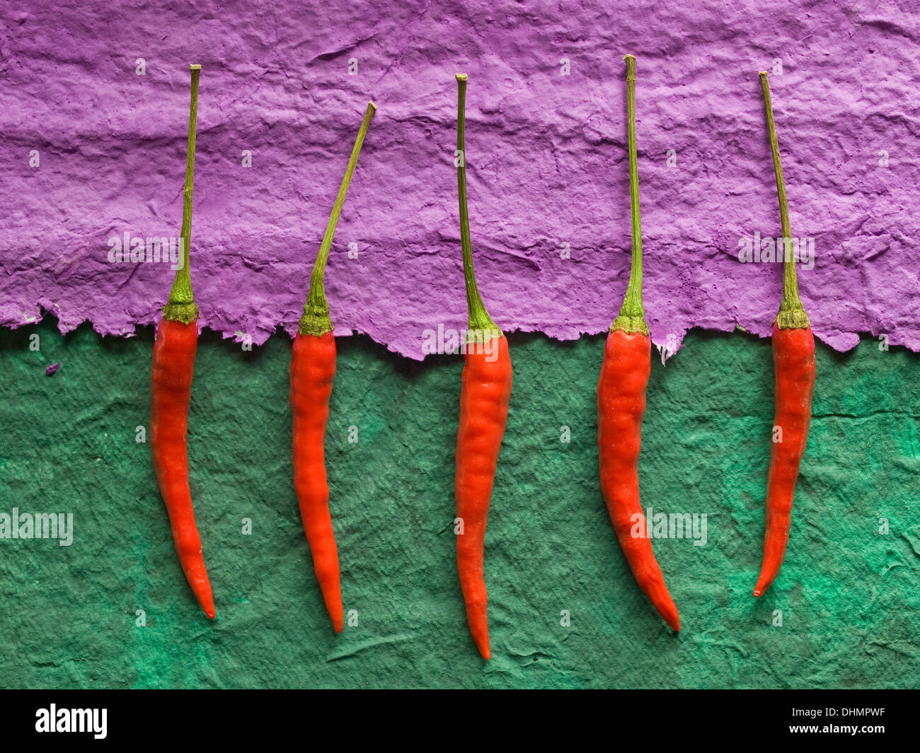 Chilli Peppers on coloured paper backgrounds Stock Photo - Alamy