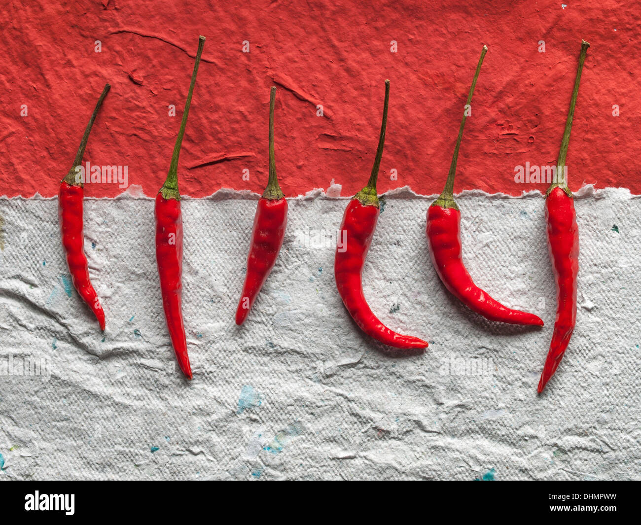 Chilli Peppers on coloured paper backgrounds Stock Photo - Alamy