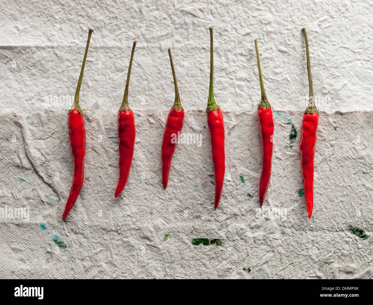 Chilli Peppers on coloured paper backgrounds Stock Photo - Alamy