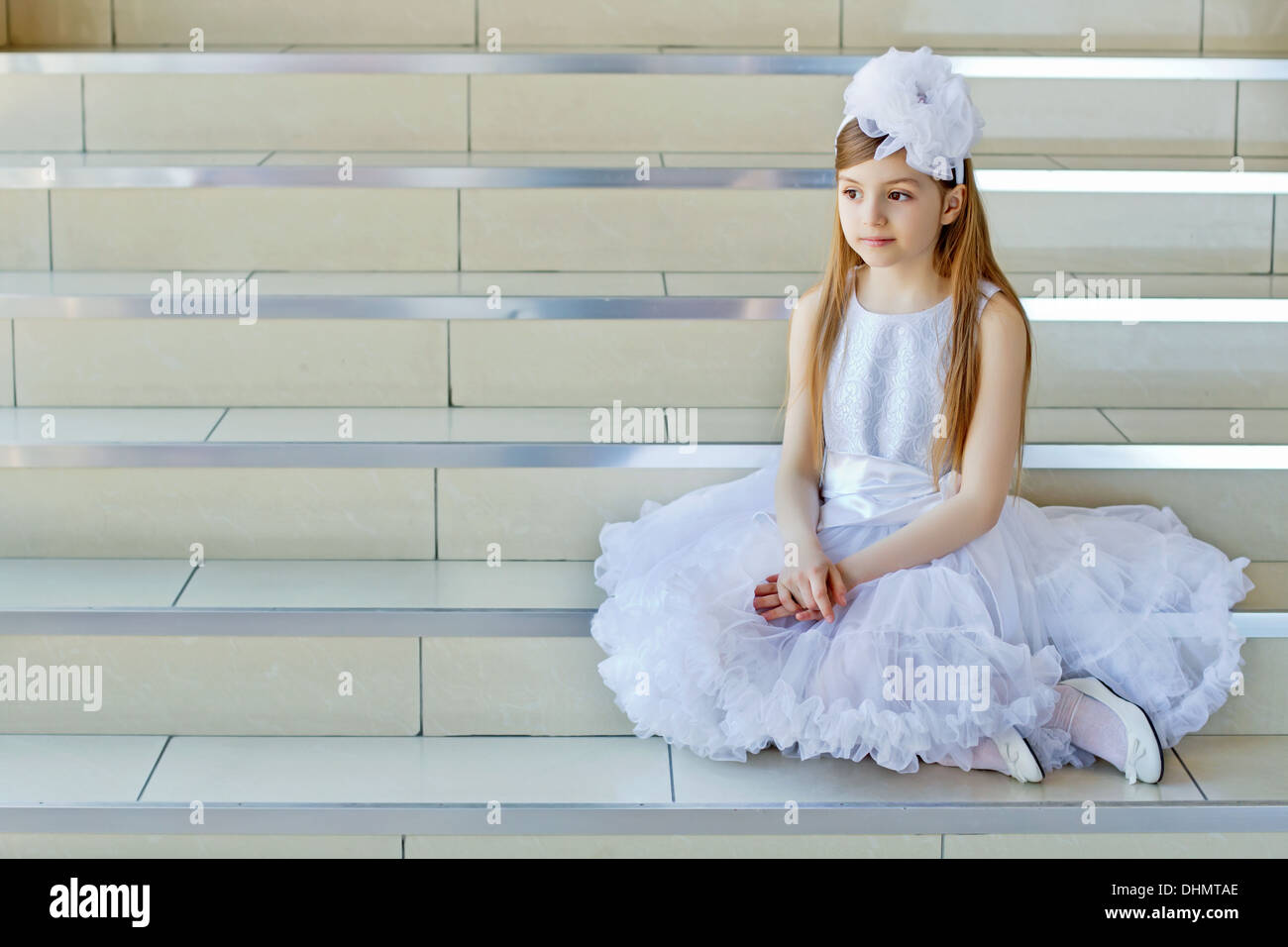 Girl sitting on the steps Stock Photo - Alamy