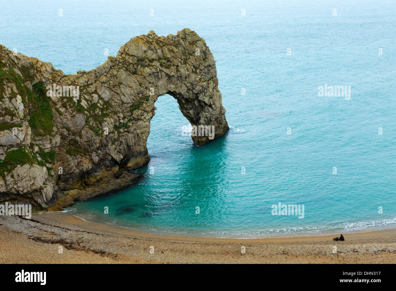 Durdle Door, Dorset. Limestone arch formed by erosion of softer rock on ...