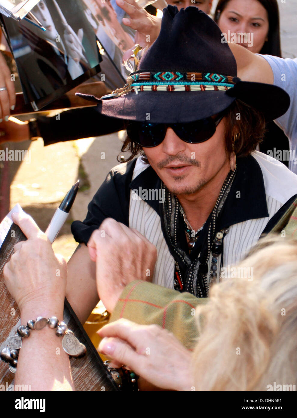 Johnny Depp signs autographs outside the El Capitan Theatre after ...