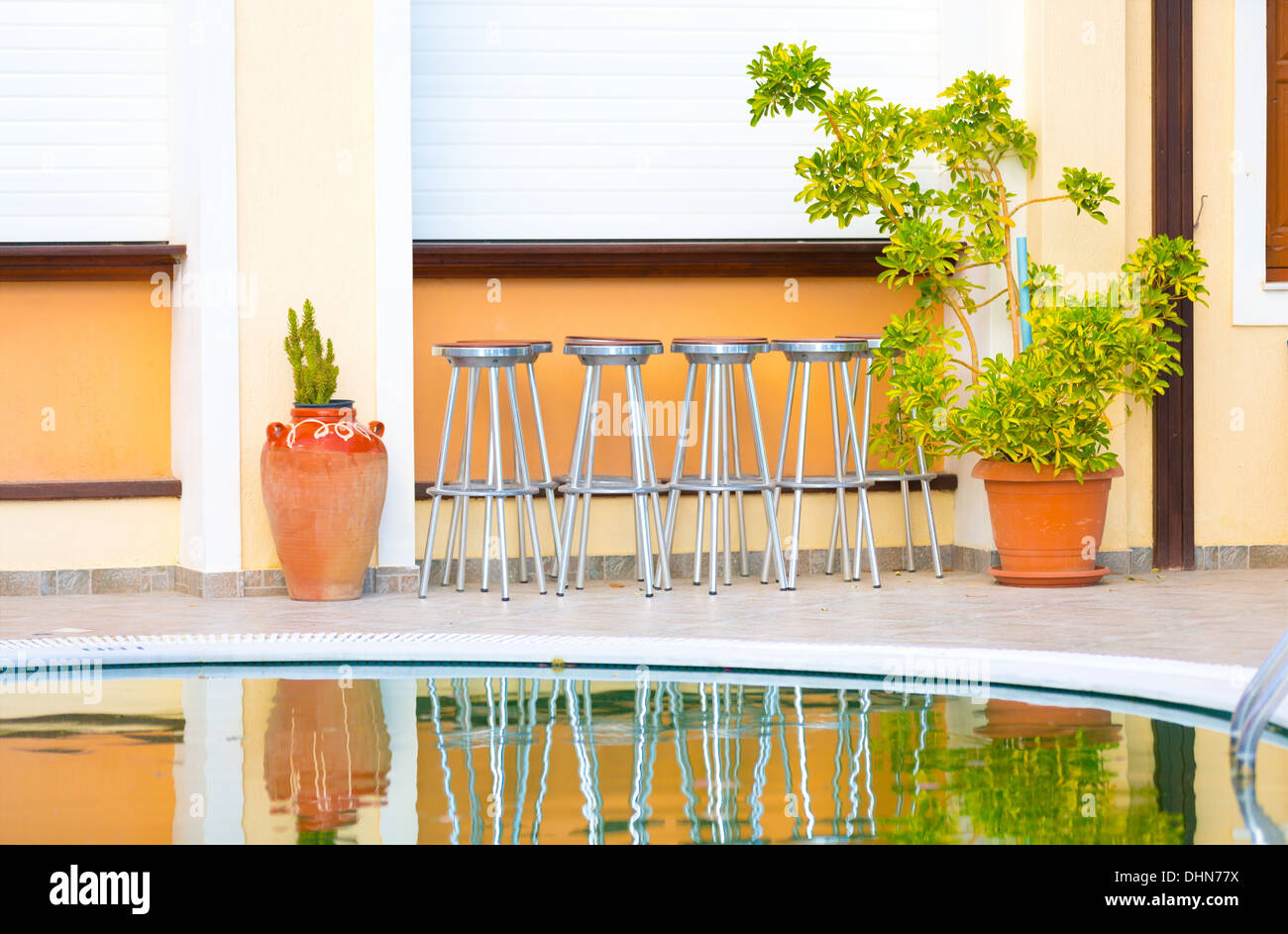 bar chairs and a swimming pool Stock Photo - Alamy