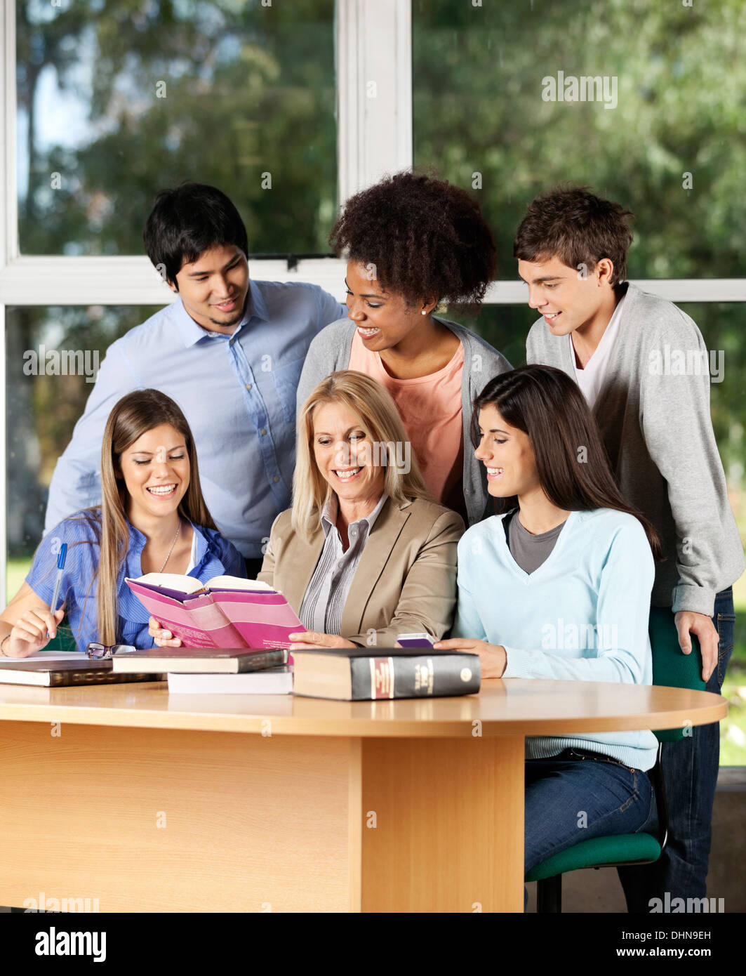 College Teacher Explaining Lesson To Students In Classroom Stock Photo ...