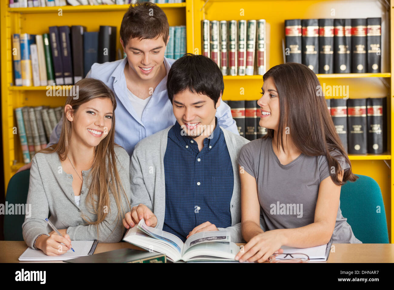 Young female asian student with books studying in library hi-res stock ...
