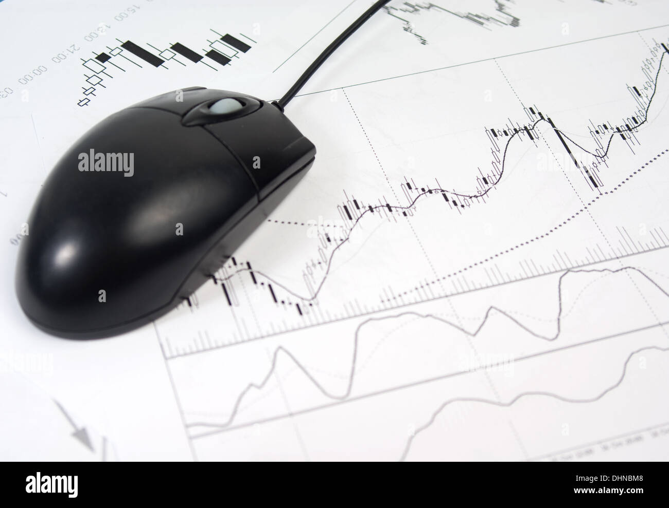 photo of black computer mouse over exchange graphs Stock Photo - Alamy