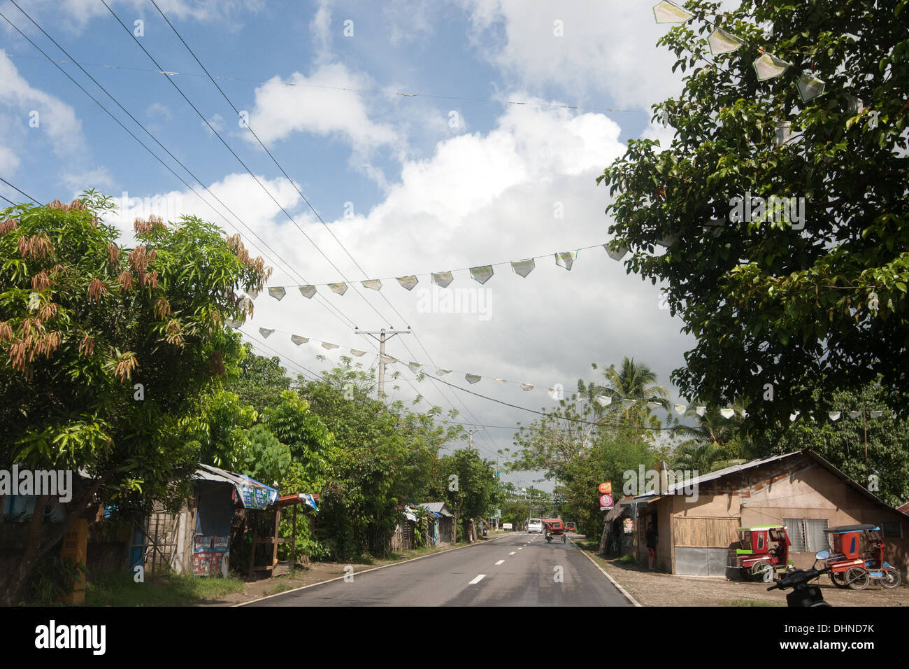 Flags hang overhead a road in Manila Stock Photo - Alamy