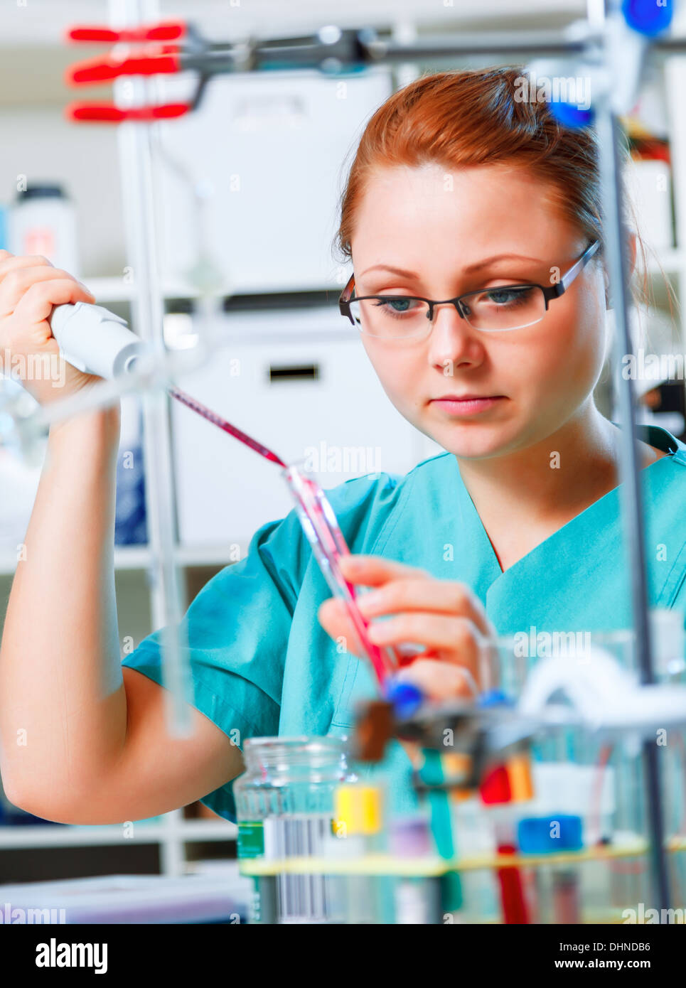 female tech or scientist works with pipette in biological laboratory ...