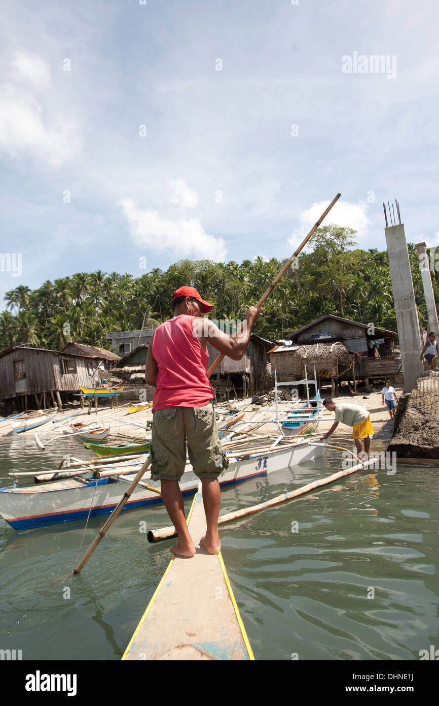 A boat operator skillfully navigates the small outrigger canoe for the ...