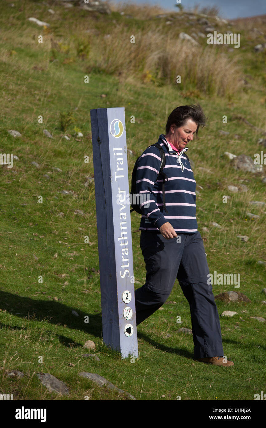 Loch Naver, Scotland. Lady walking on the Strathnaver Trail at Grumbeg ...