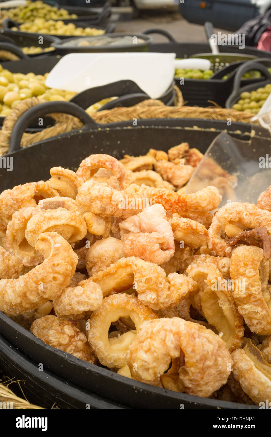 Traditional chicharrones, fried pork rind, on display at a market stall ...