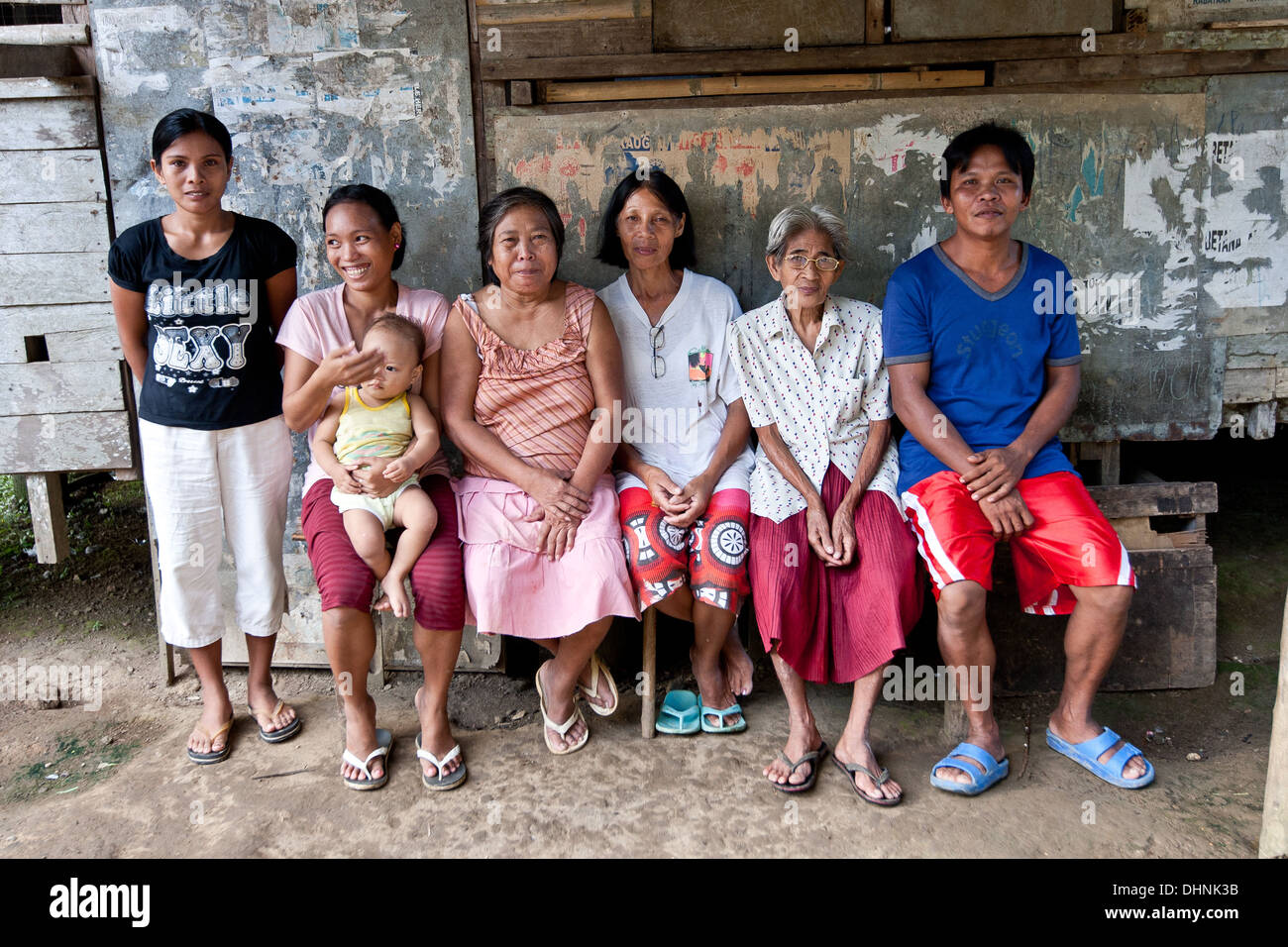 A group of women and children sit together at a house church on the ...