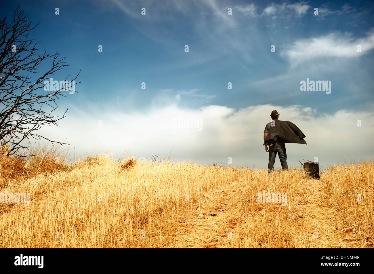 Man standing in a field Stock Photo - Alamy