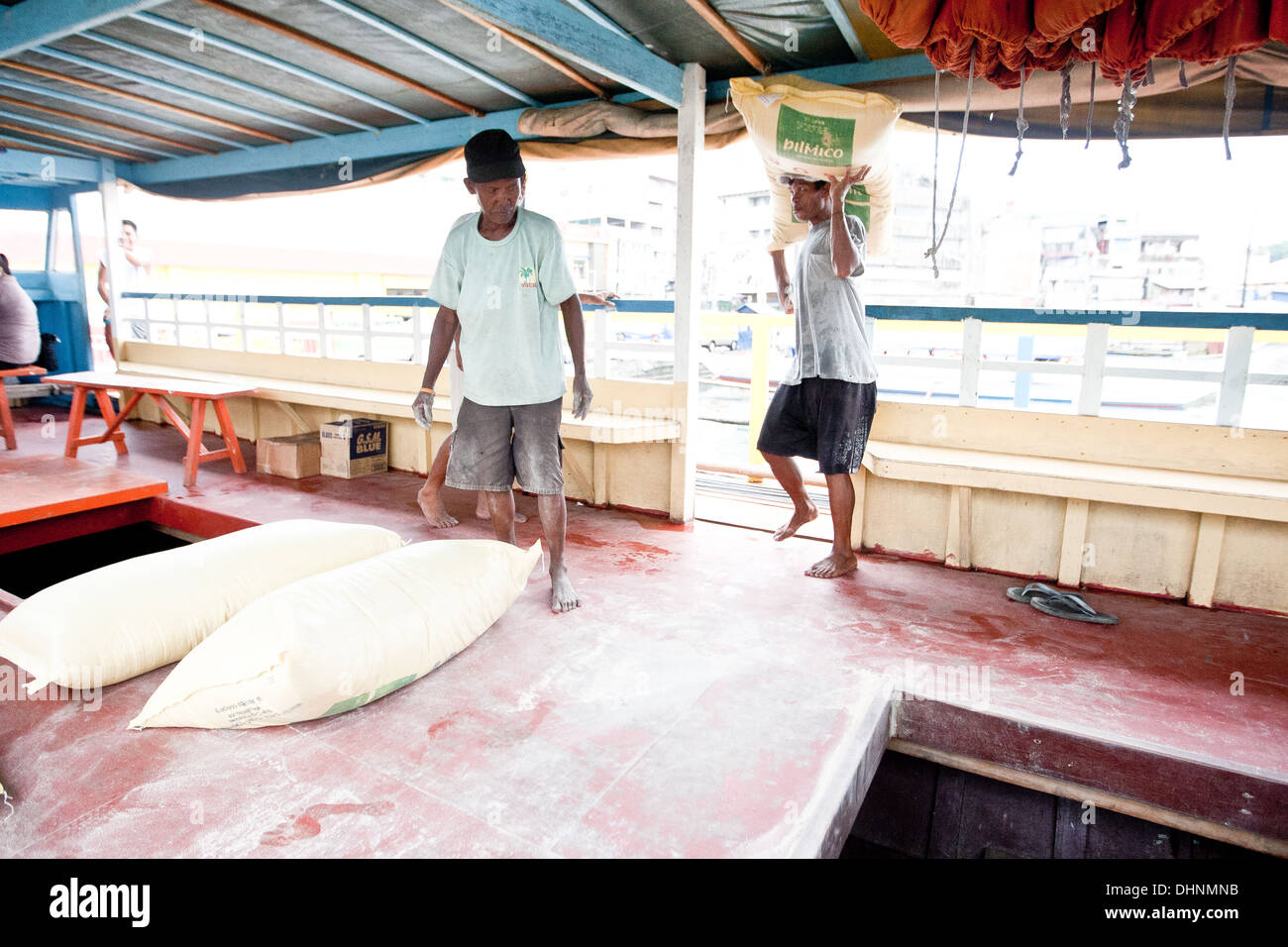 Men load their boats at a wharf at Tacloban City, Leyte Stock Photo - Alamy