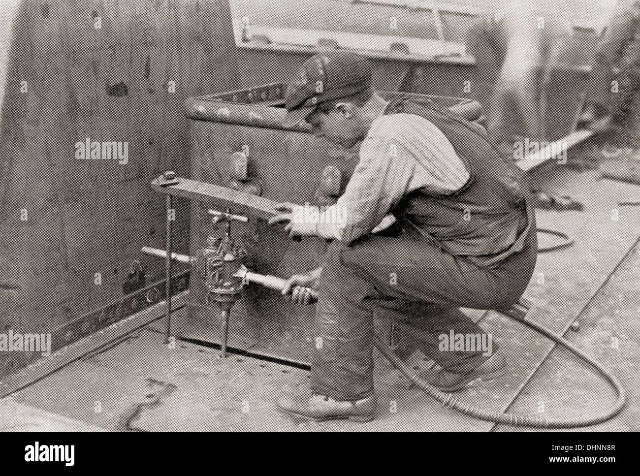 Worker using a Thor Pneumatic drill Stock Photo - Alamy
